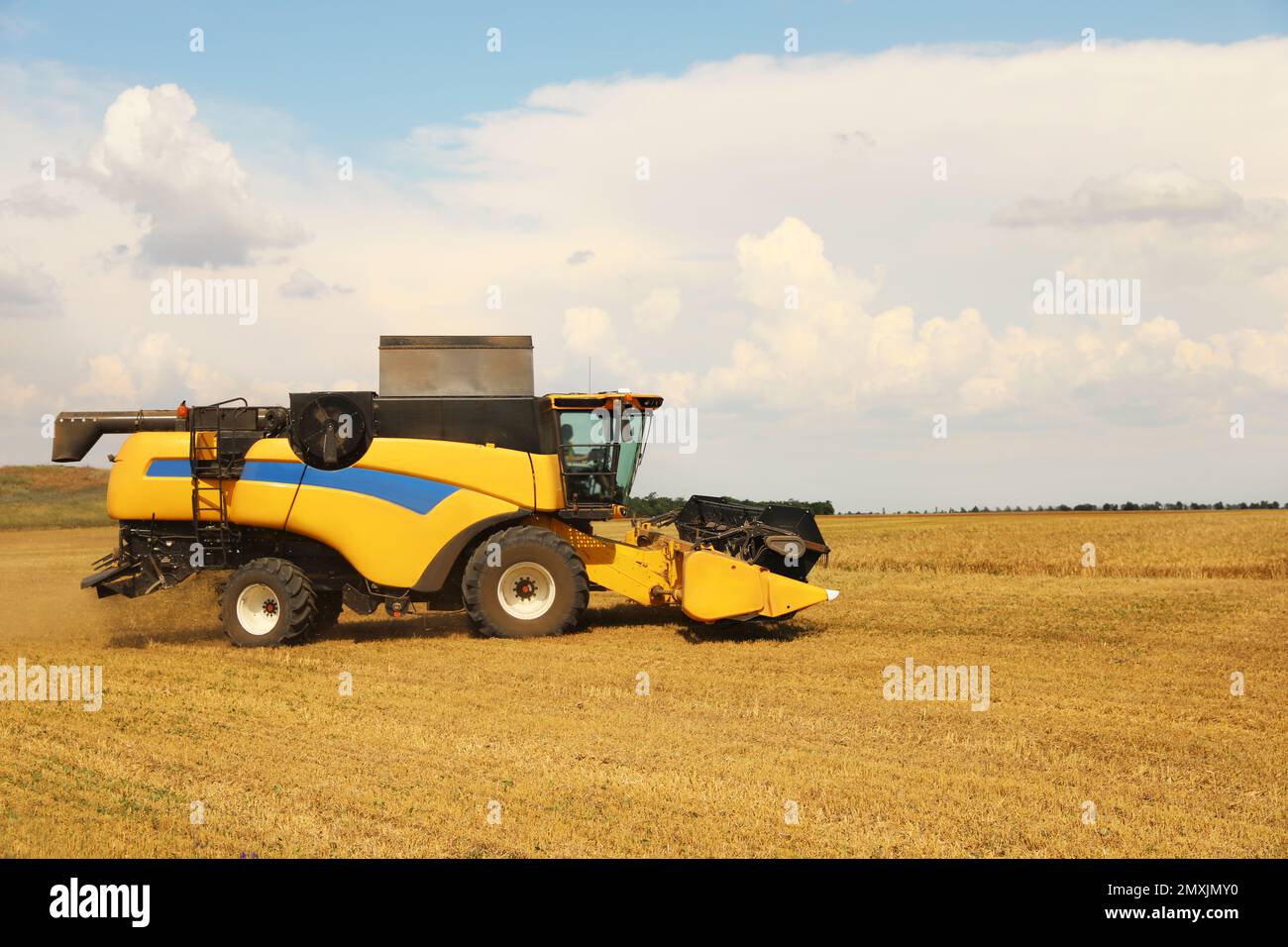 Modern combine harvester in field on sunny day. Agricultural machinery ...