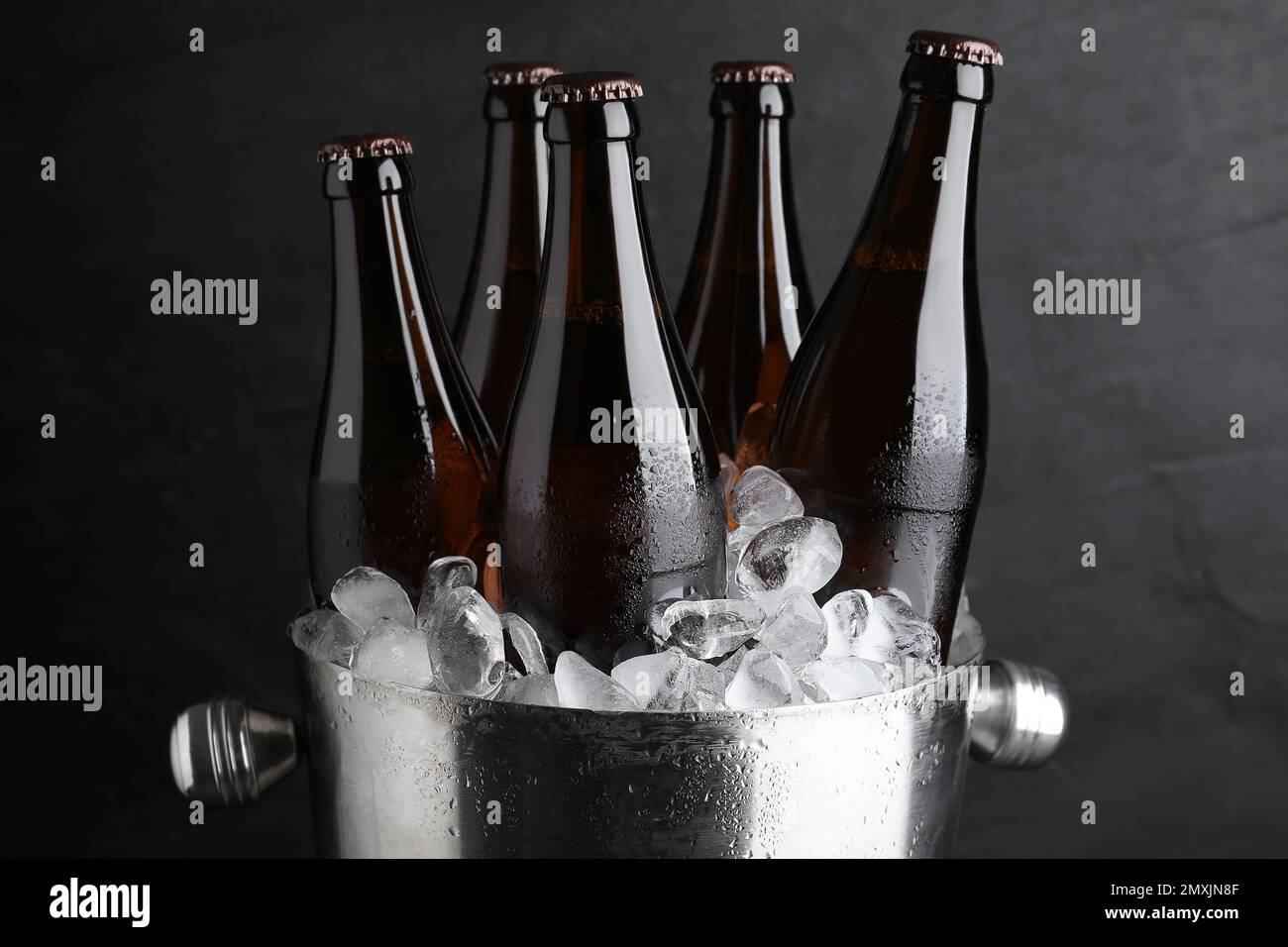 Metal bucket with beer and ice cubes on black background, closeup Stock ...