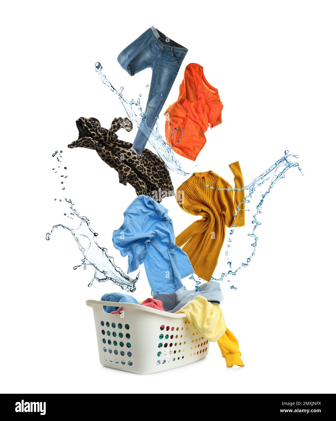 Different clothes with water splash falling into laundry basket against ...