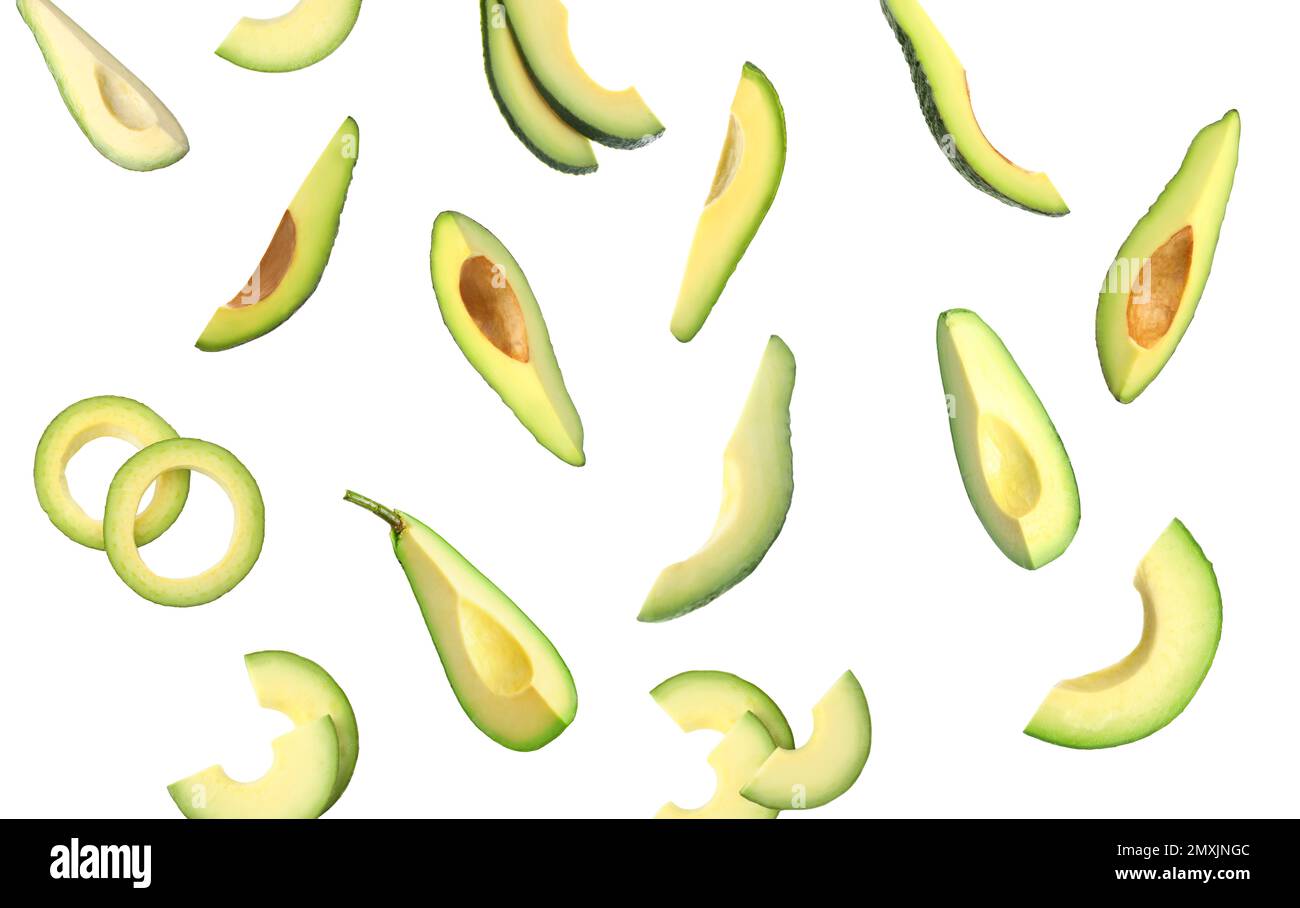 Fresh avocado slices falling on white background Stock Photo - Alamy