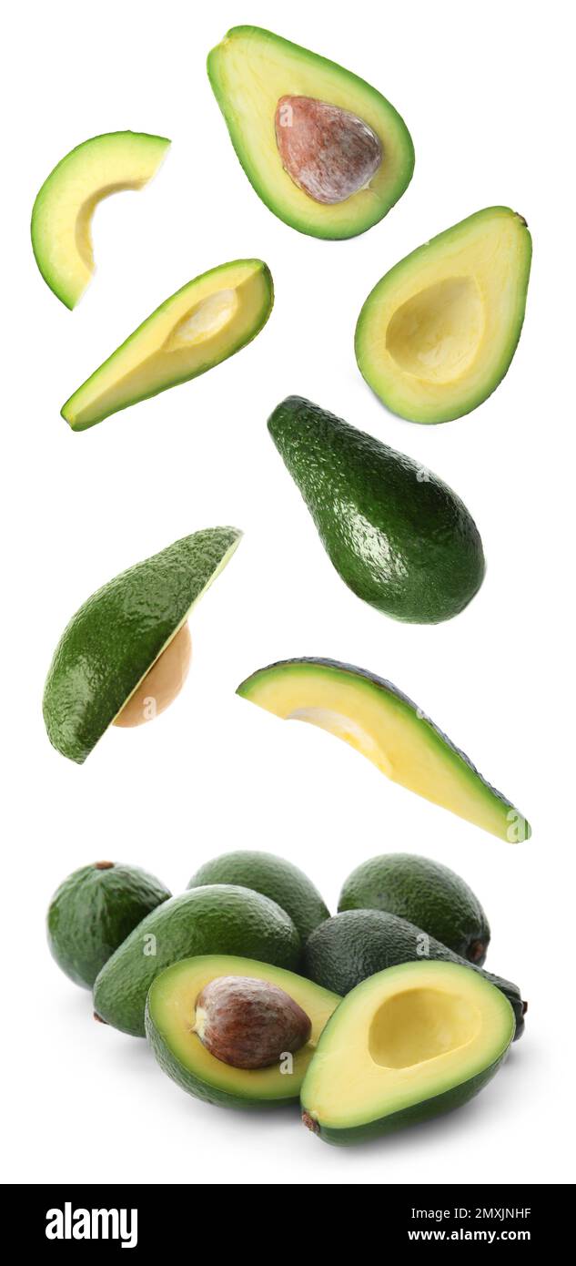 Fresh ripe avocados falling on white background Stock Photo - Alamy