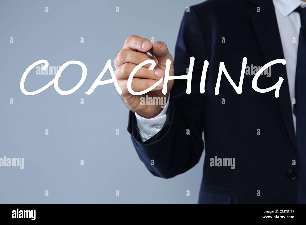 Business trainer writing word Coaching on virtual screen, closeup Stock ...