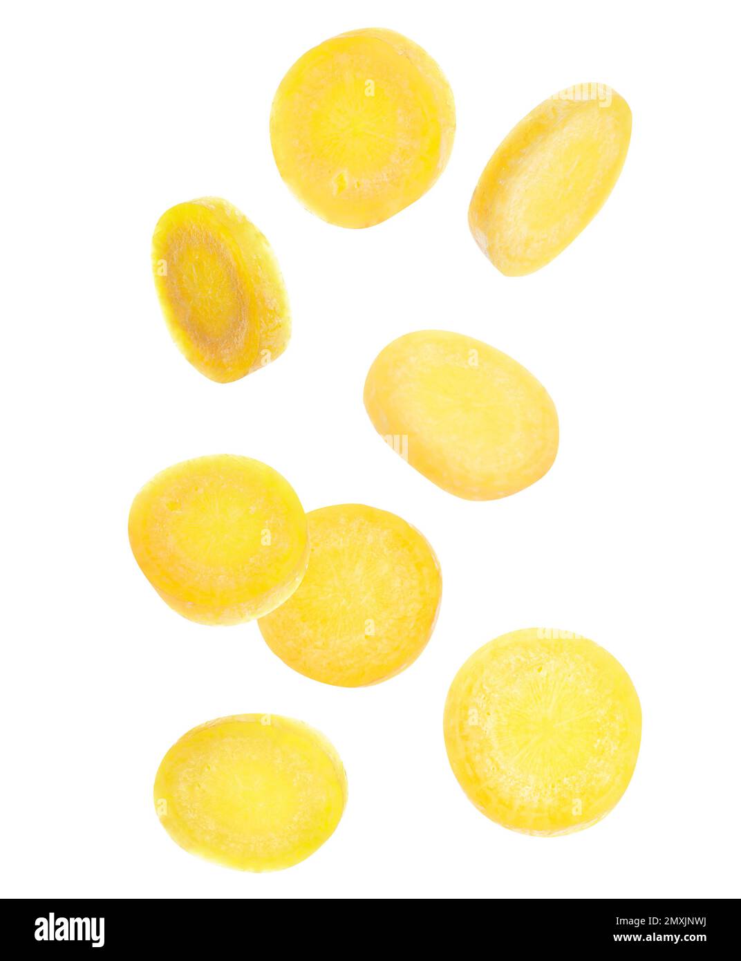 Yellow carrot slices falling on white background Stock Photo - Alamy