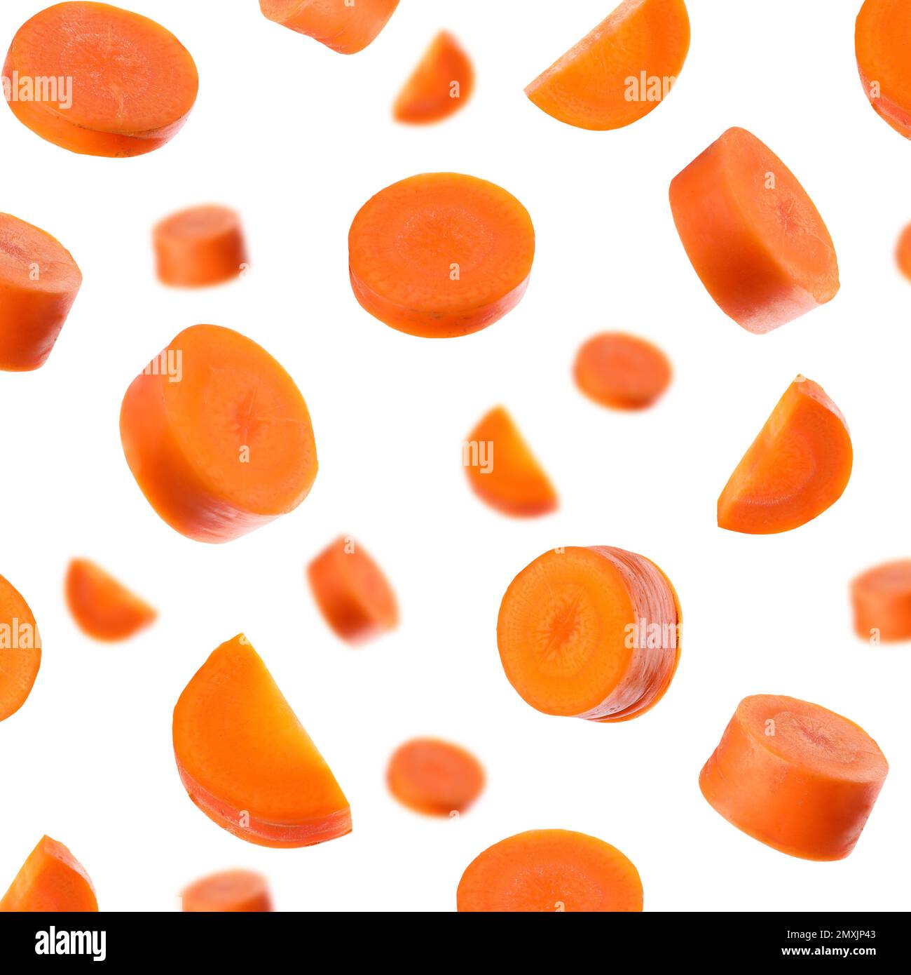 Fresh carrot slices falling on white background Stock Photo - Alamy