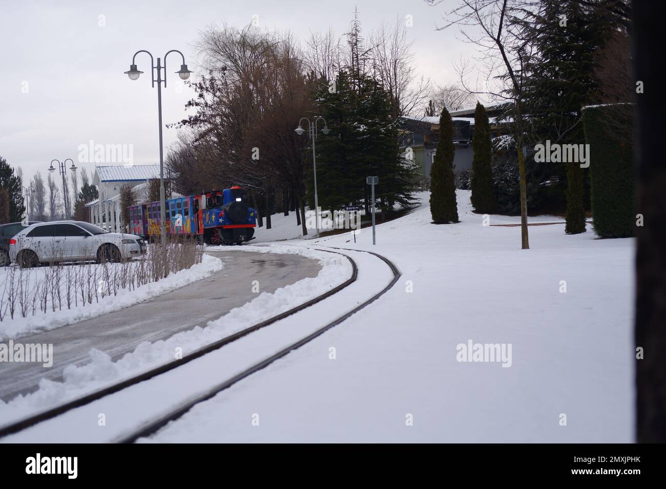 Railroad tracks covered with snow in cold winter with near pine trees ...