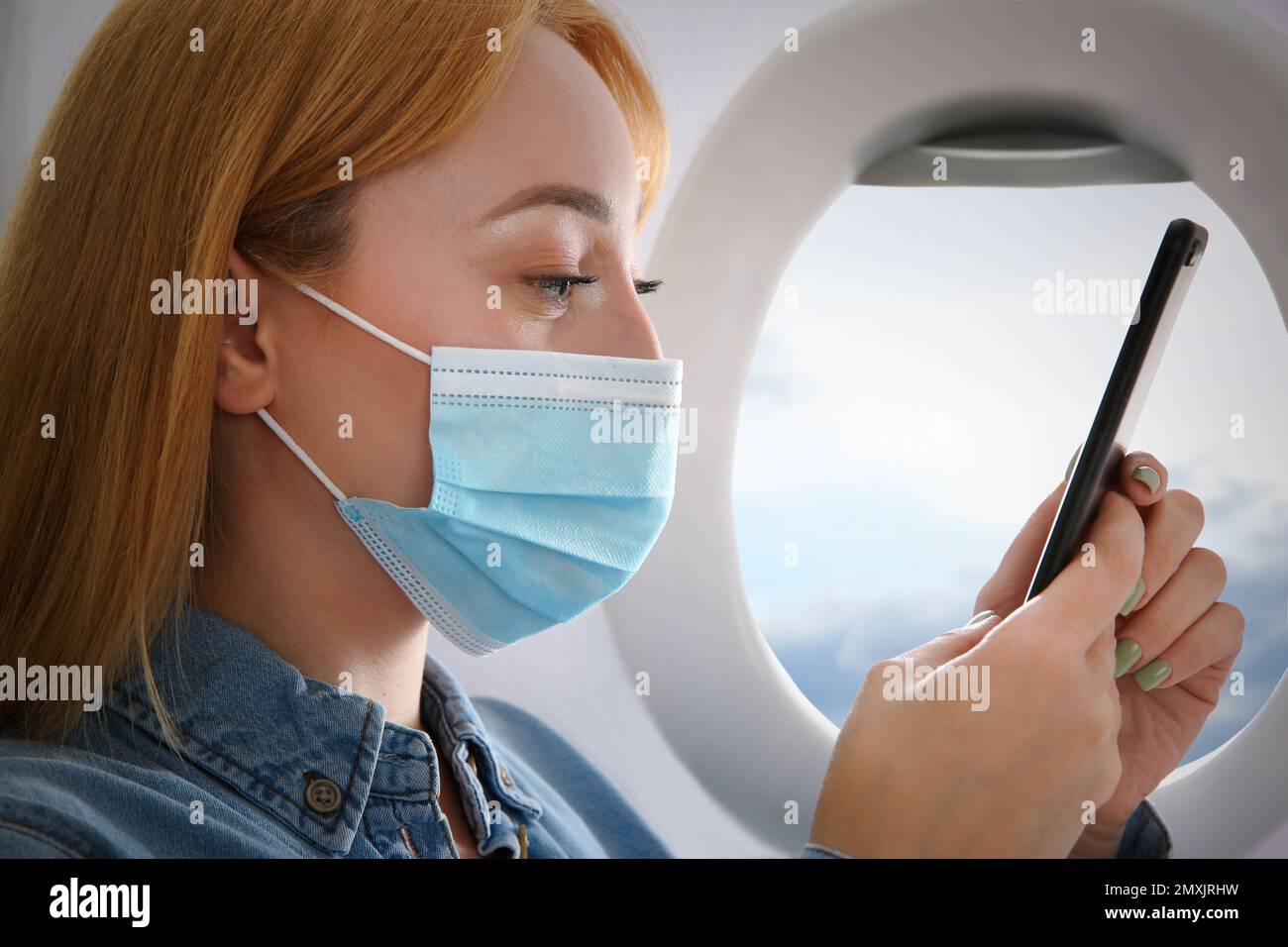 Traveling by airplane during coronavirus pandemic. Woman with face mask ...