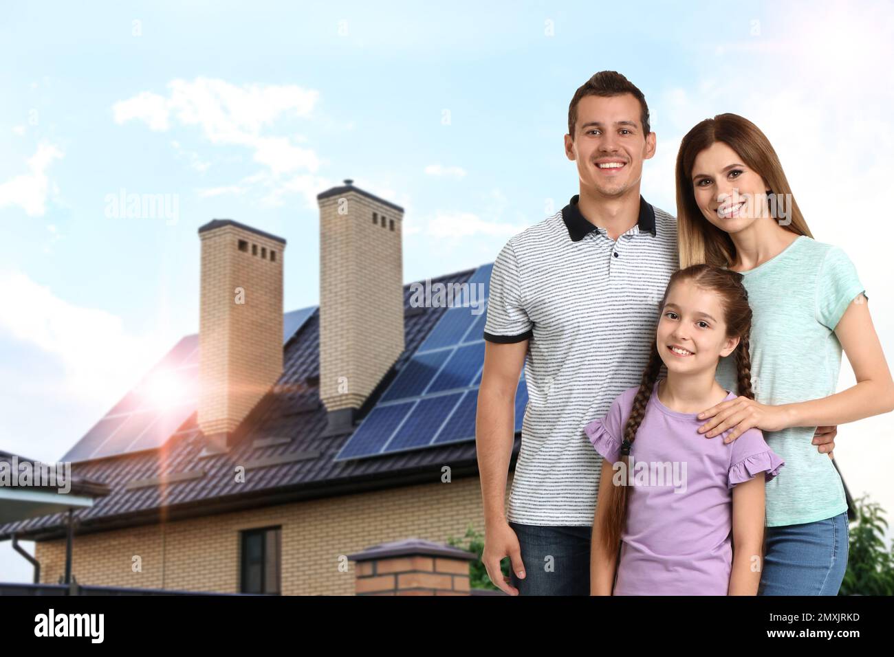 Happy family near their house with solar panels. Alternative energy ...