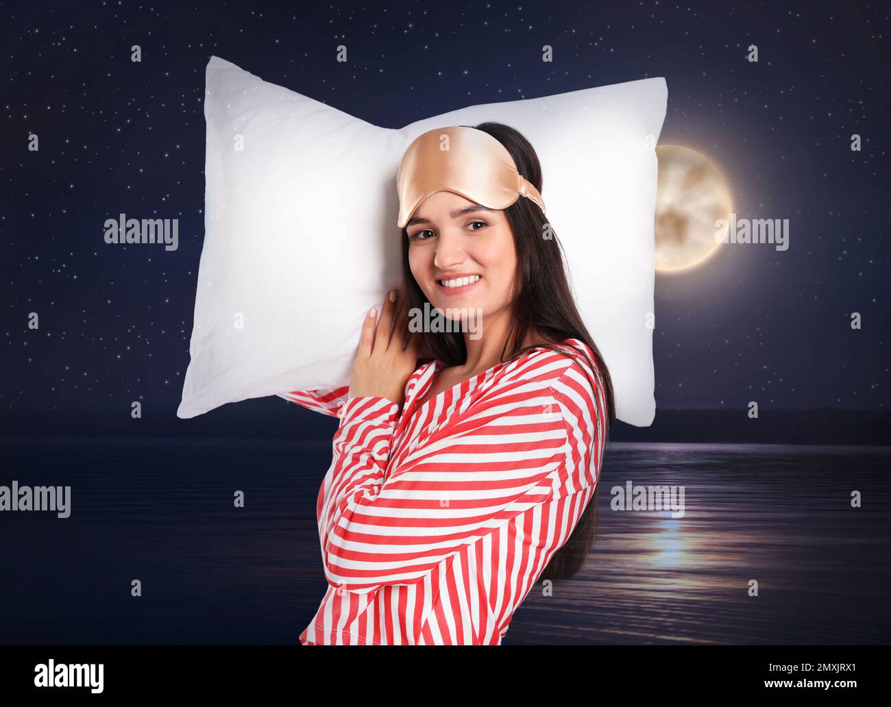 Beautiful woman holding pillow and night starry sky with full moon on ...