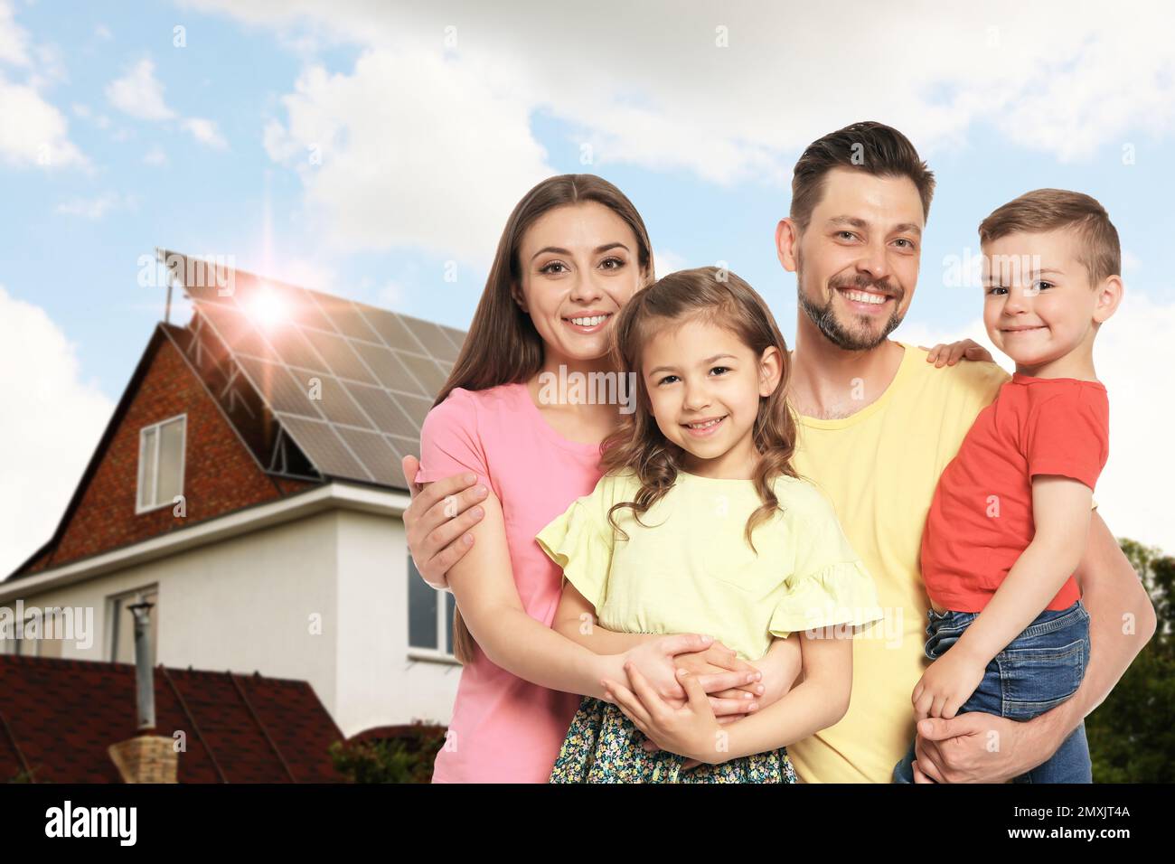 Happy family near their house with solar panels. Alternative energy ...