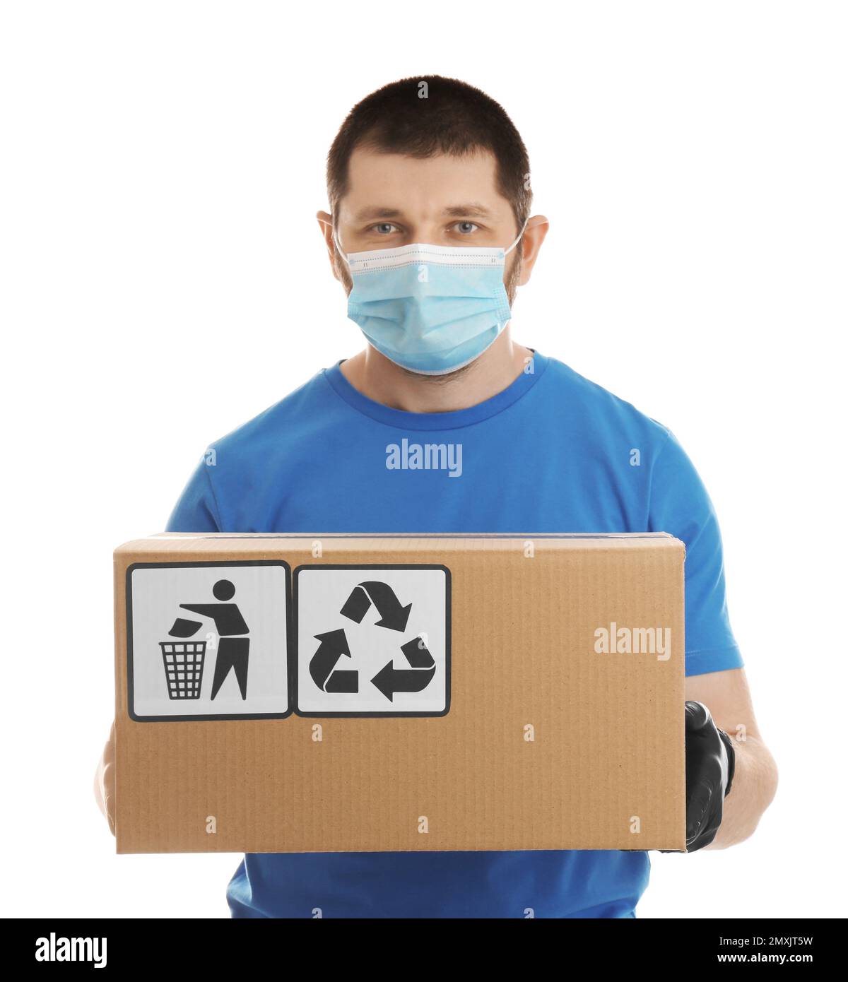 Courier in mask holding cardboard box with different packaging symbols ...