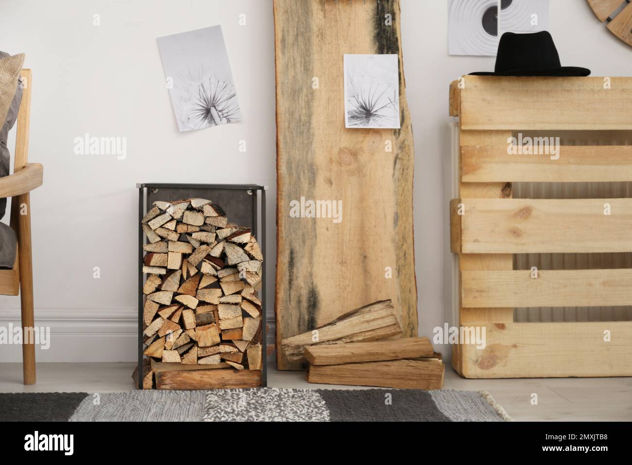 Firewood as decorative element in stylish room interior Stock Photo - Alamy