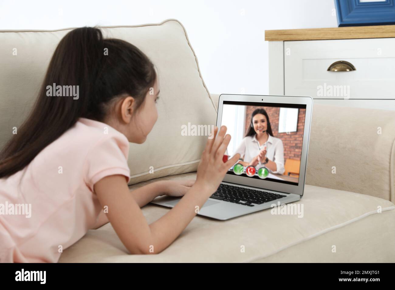 Distance learning, studying at home. Girl having online school lesson ...