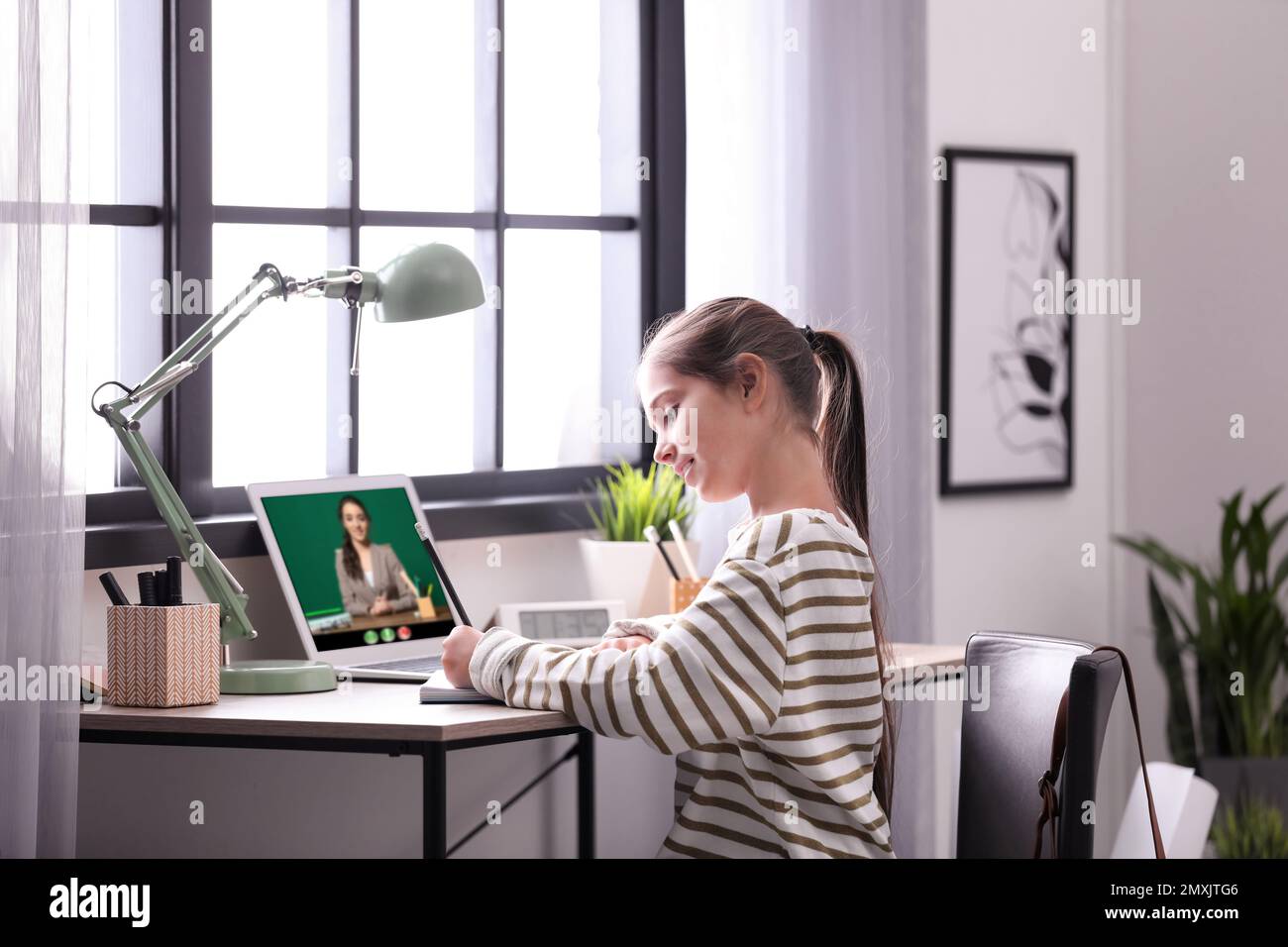 Distance learning, online school lesson. Girl studying at home during ...