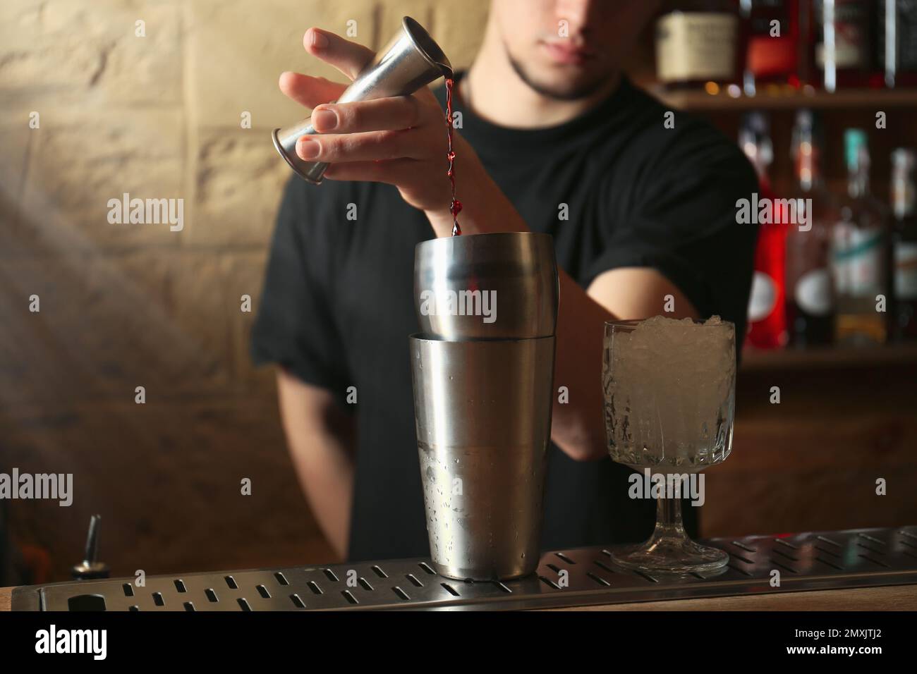 Bartender preparing fresh alcoholic cocktail at bar counter, closeup ...