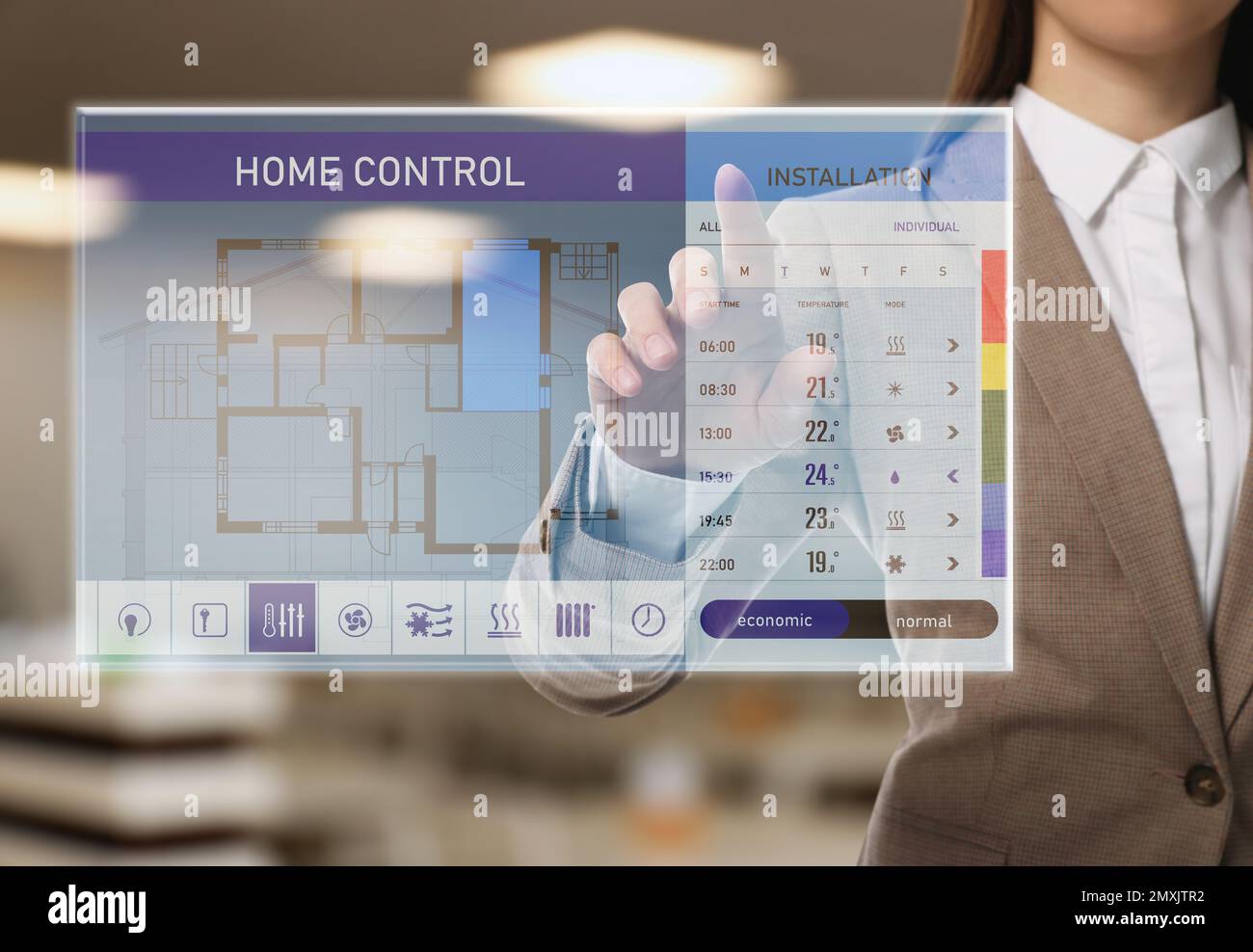 Woman using touchscreen panel to set indoor temperature, closeup. Smart ...