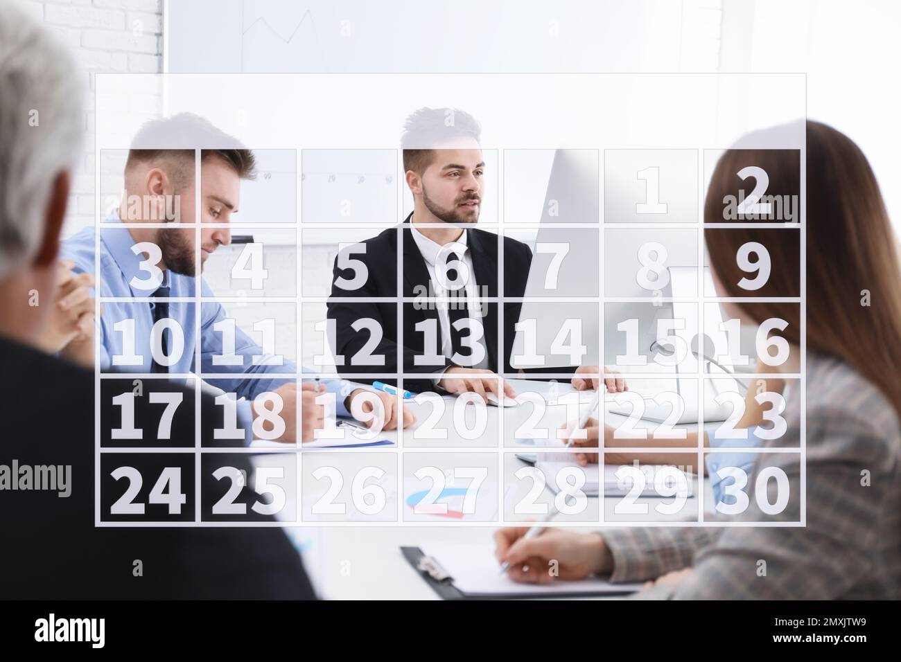 Calendar and people having business meeting in office Stock Photo - Alamy