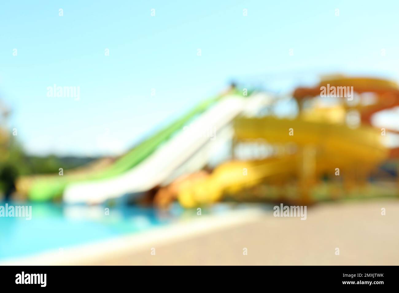 Different colorful slides in water park, blurred view Stock Photo - Alamy