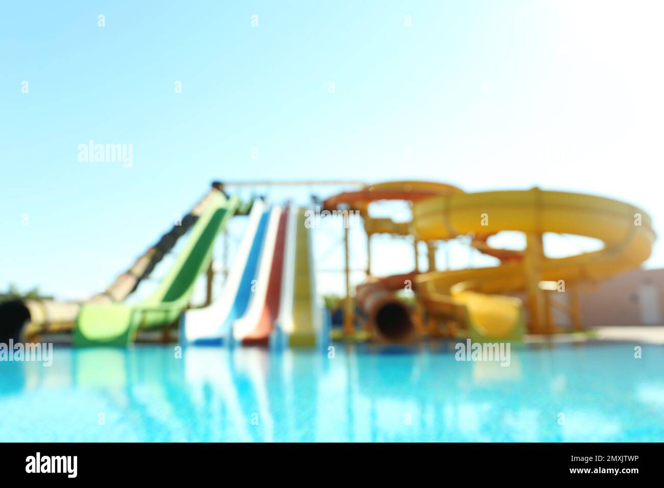 Different colorful slides in water park, blurred view Stock Photo - Alamy
