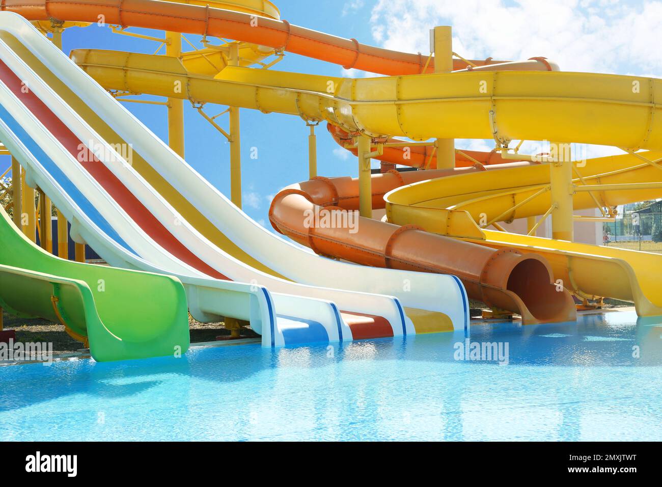 Different colorful slides in water park on sunny day Stock Photo - Alamy