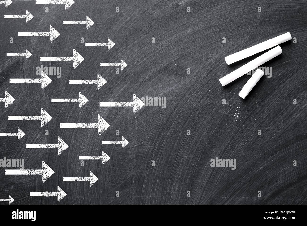 Choose your way. Arrows and pieces of chalk on blackboard, top view ...