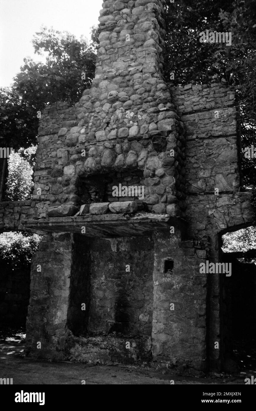 The ruins of a massive two story stone fireplace and chimney at ...