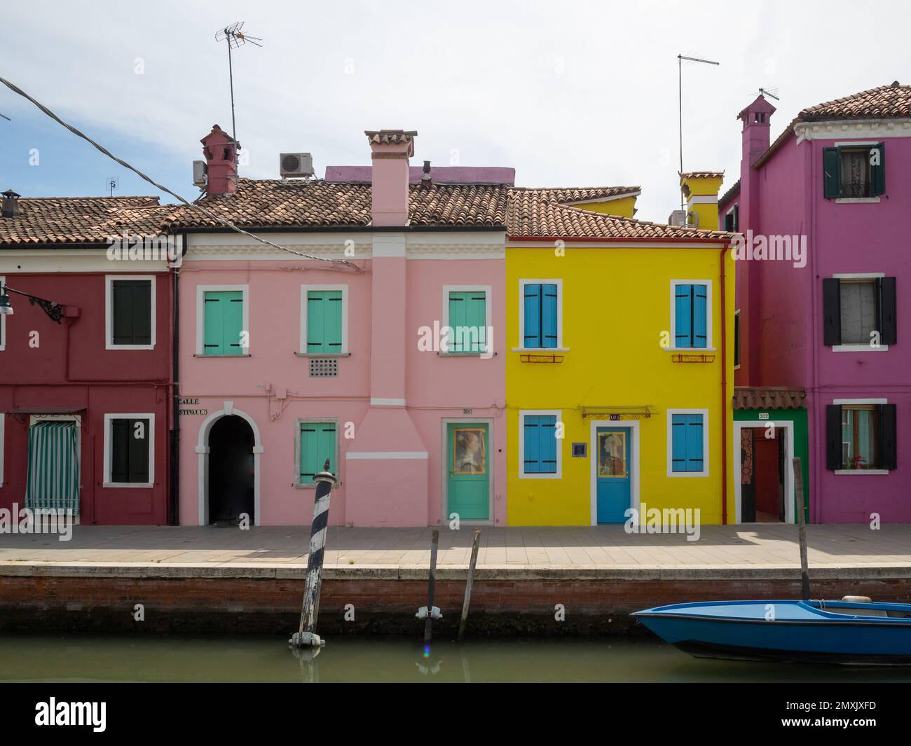 Burano colorful houses facades by the canal Stock Photo - Alamy