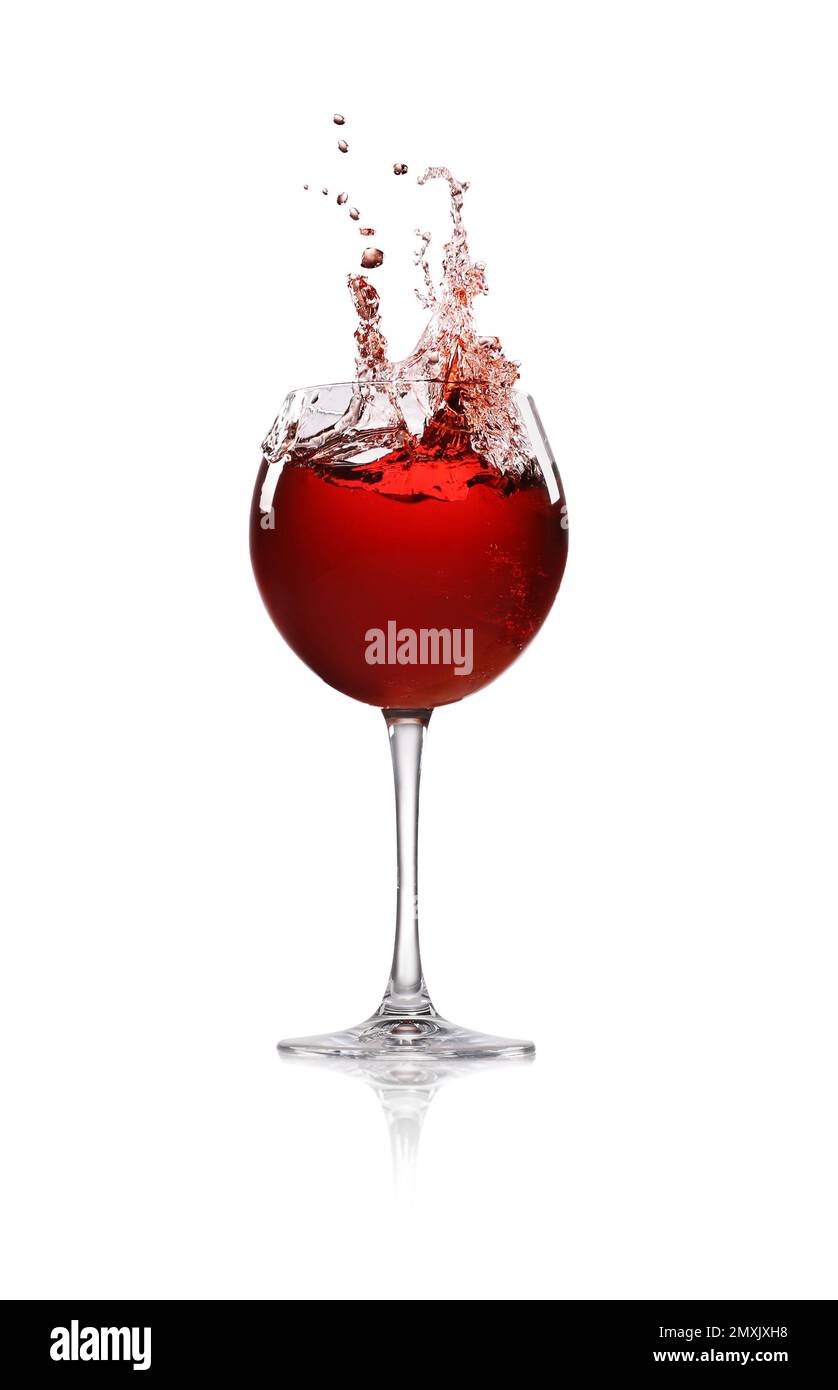 Red wine splashing in glass on white background Stock Photo - Alamy