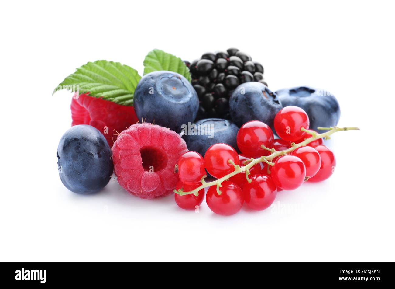 Pile of different ripe tasty berries with green leaves isolated on ...