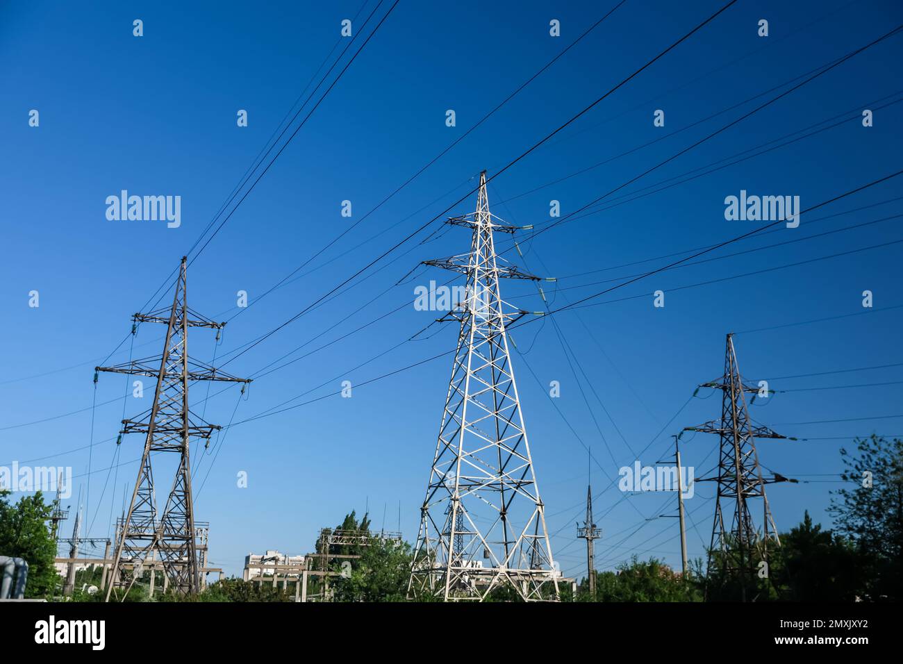 Modern high voltage towers against blue sky Stock Photo - Alamy