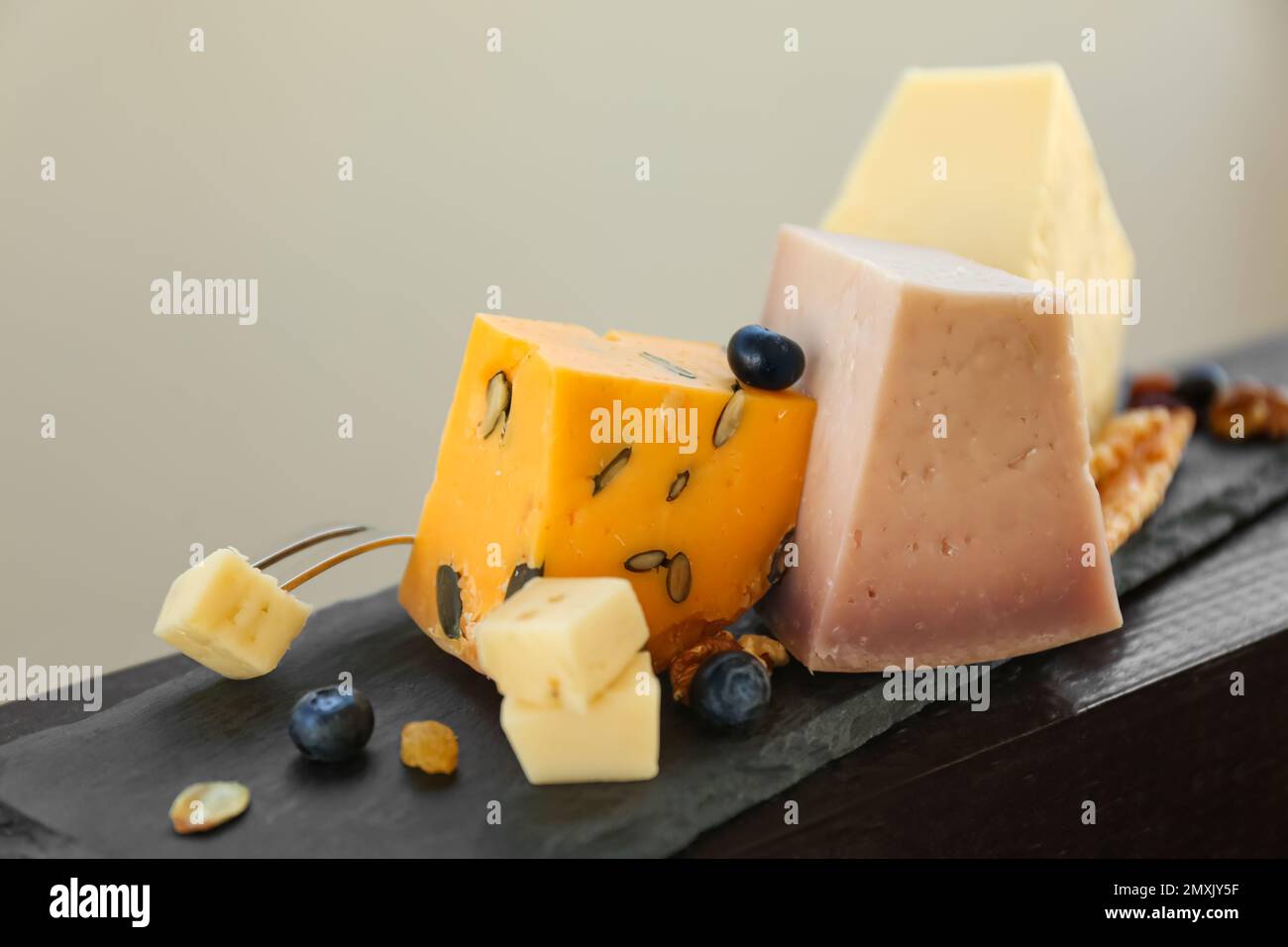 Different types of delicious cheeses on slate plate, closeup Stock ...