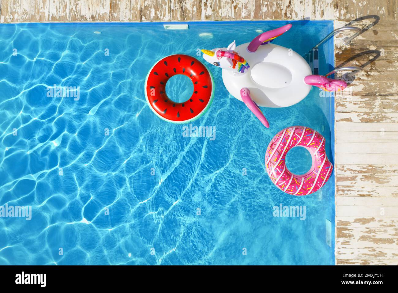 Swimming pool with inflatable rings, top view Stock Photo - Alamy