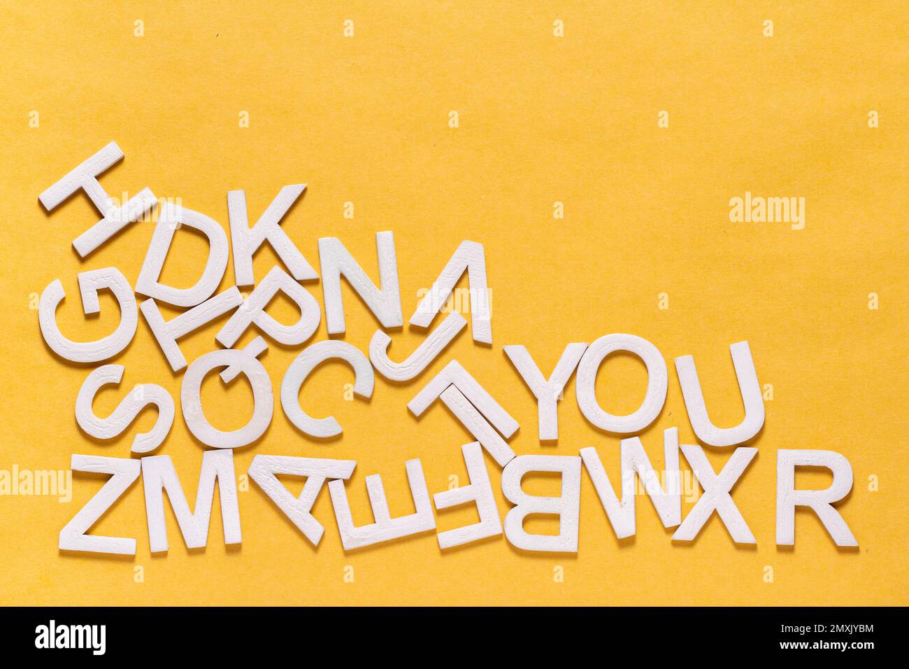Set of letters of the alphabet in disorder, on yellow background, top ...