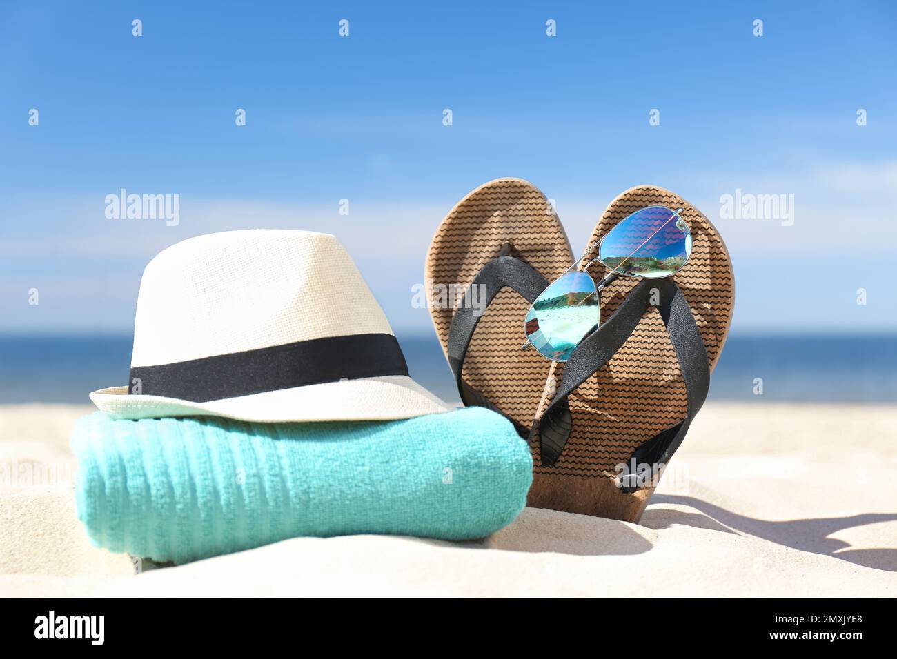 Stylish beach accessories for summer vacation on sand near sea Stock ...