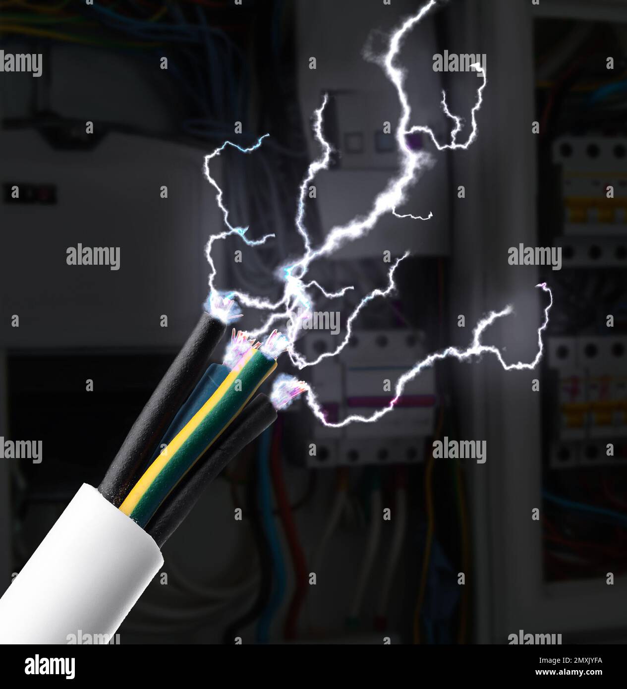Sparking cables against blurred electric cabinet, closeup Stock Photo ...