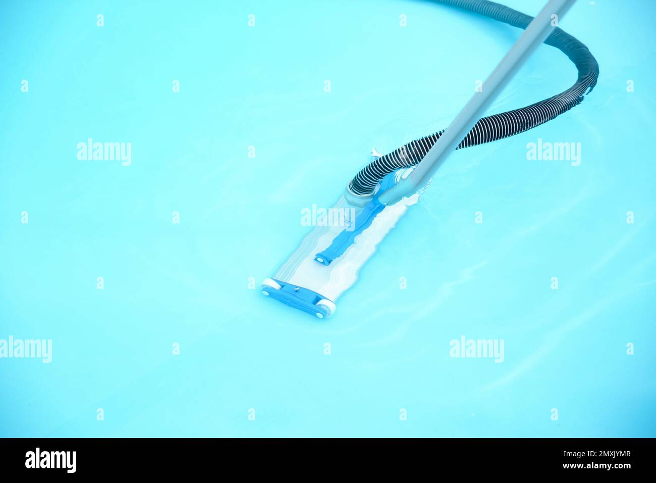 Cleaning outdoor pool with underwater vacuum, closeup Stock Photo - Alamy