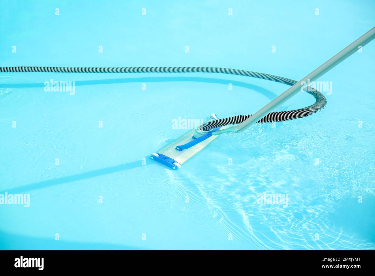 Cleaning outdoor pool with underwater vacuum, closeup Stock Photo - Alamy