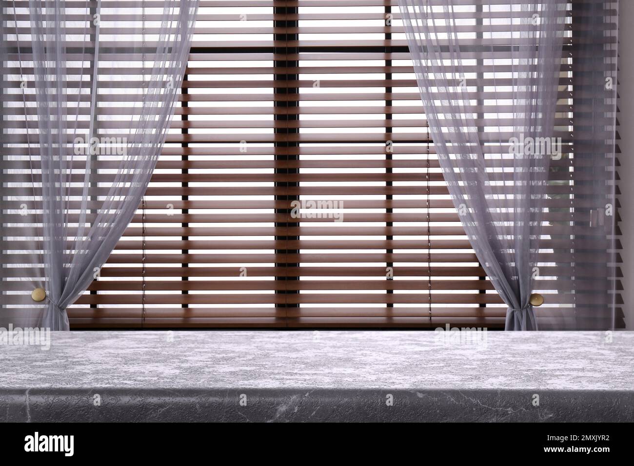 Stone table near window with blinds and curtains Stock Photo - Alamy