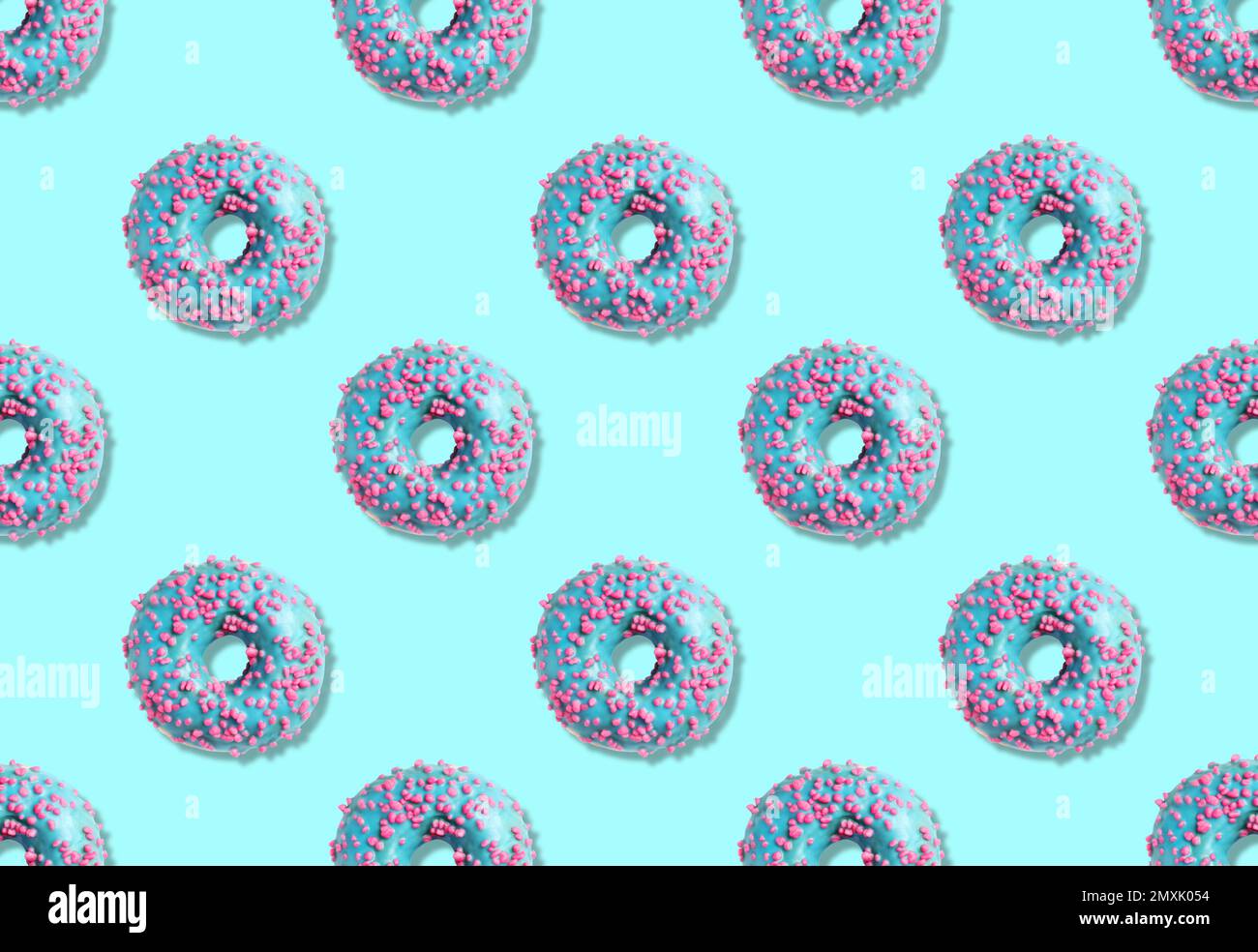 Creative pattern design of glazed donuts on light blue background Stock ...