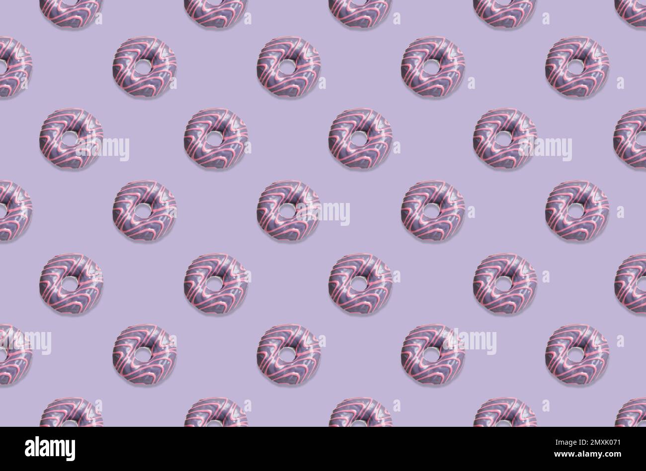 Creative pattern design of glazed donuts on pale purple background ...
