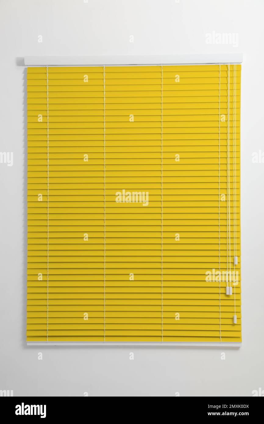 Window with closed yellow blinds in room Stock Photo - Alamy