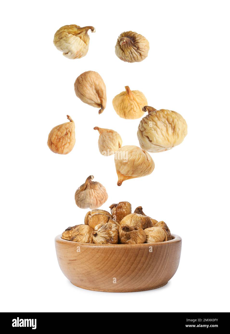 Dried fig fruits falling into bowl on white background Stock Photo - Alamy