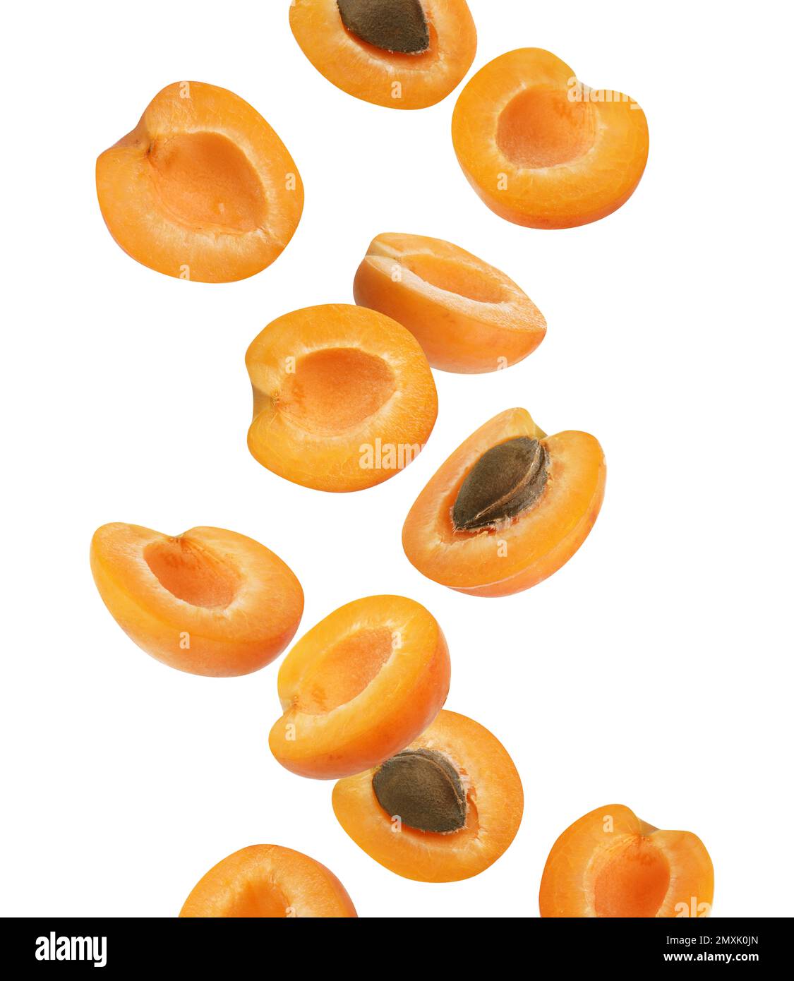 Cut ripe apricots falling on white background Stock Photo - Alamy