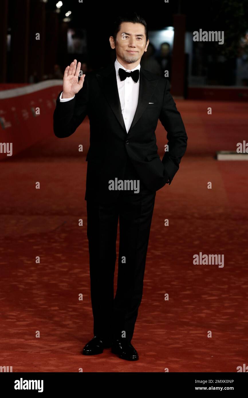 Actor Masahiro Motoki poses for photographers as he arrives on the red ...