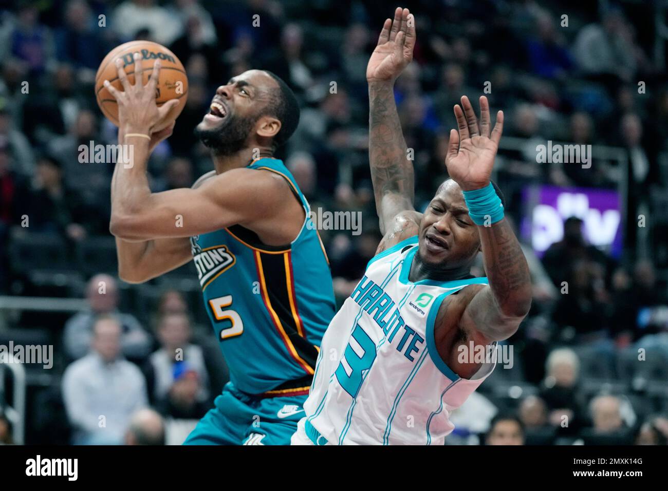 Detroit Pistons guard Alec Burks (5) is fouled by Charlotte Hornets ...