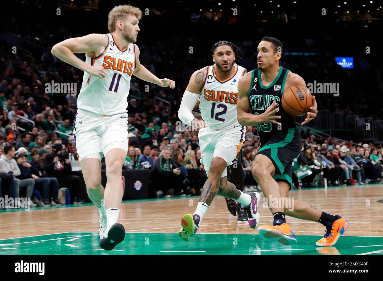 Boston Celtics' Malcolm Brogdon (13) drives for the basket against ...