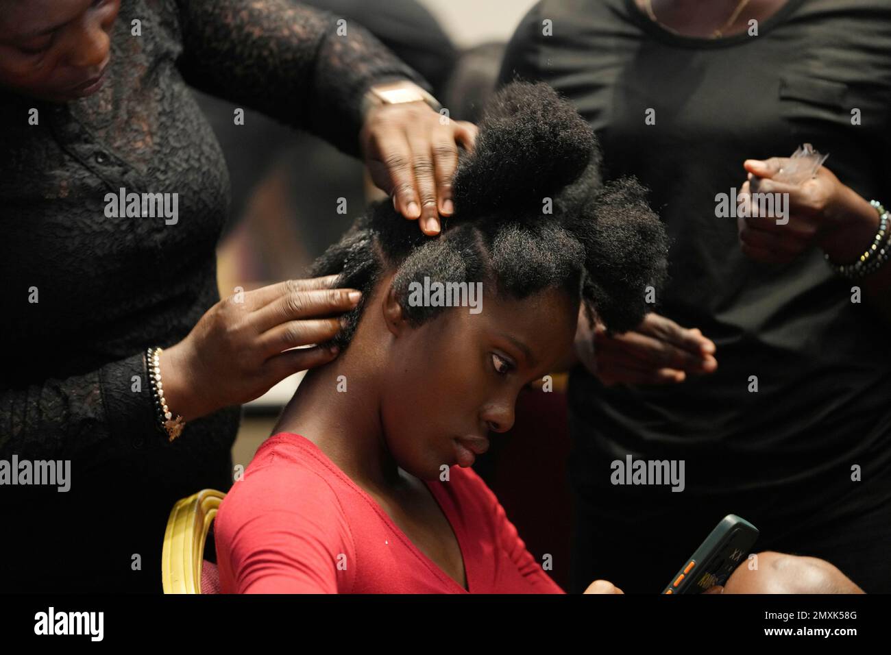 A model does her hair backstage before the ARISE Fashion Week event in ...