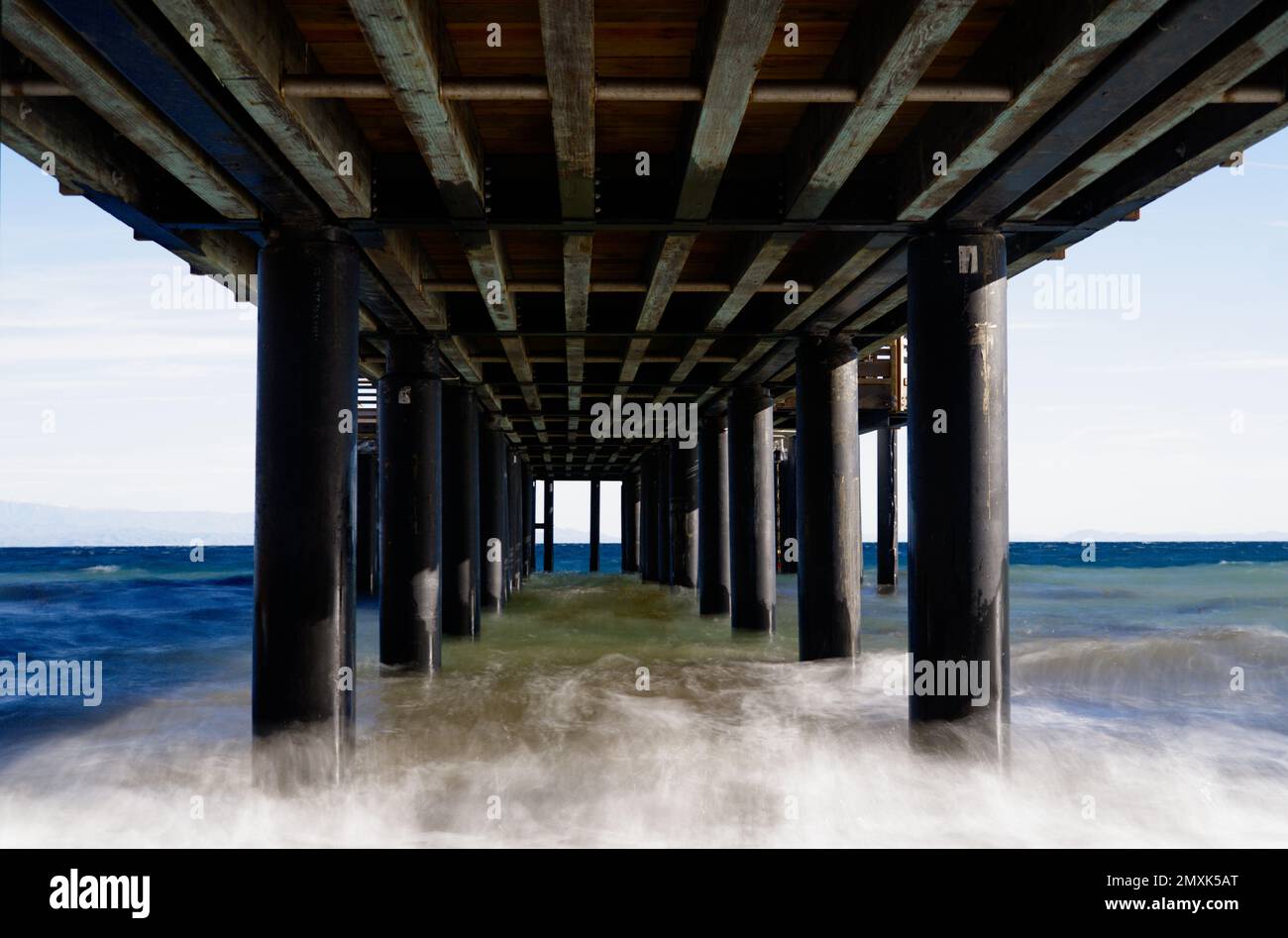 The view under a pier at the seashore Stock Photo - Alamy
