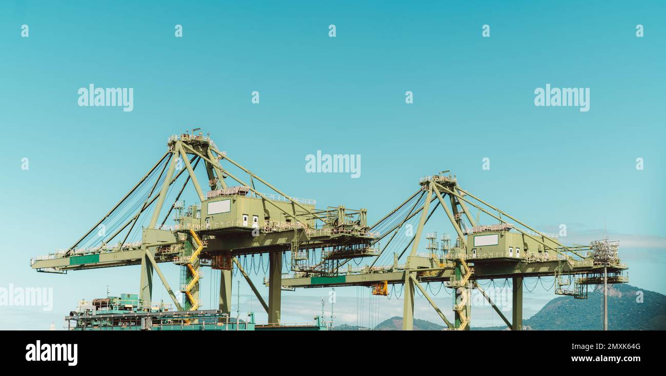 The capture of two massive yellow container handling cranes at work at ...