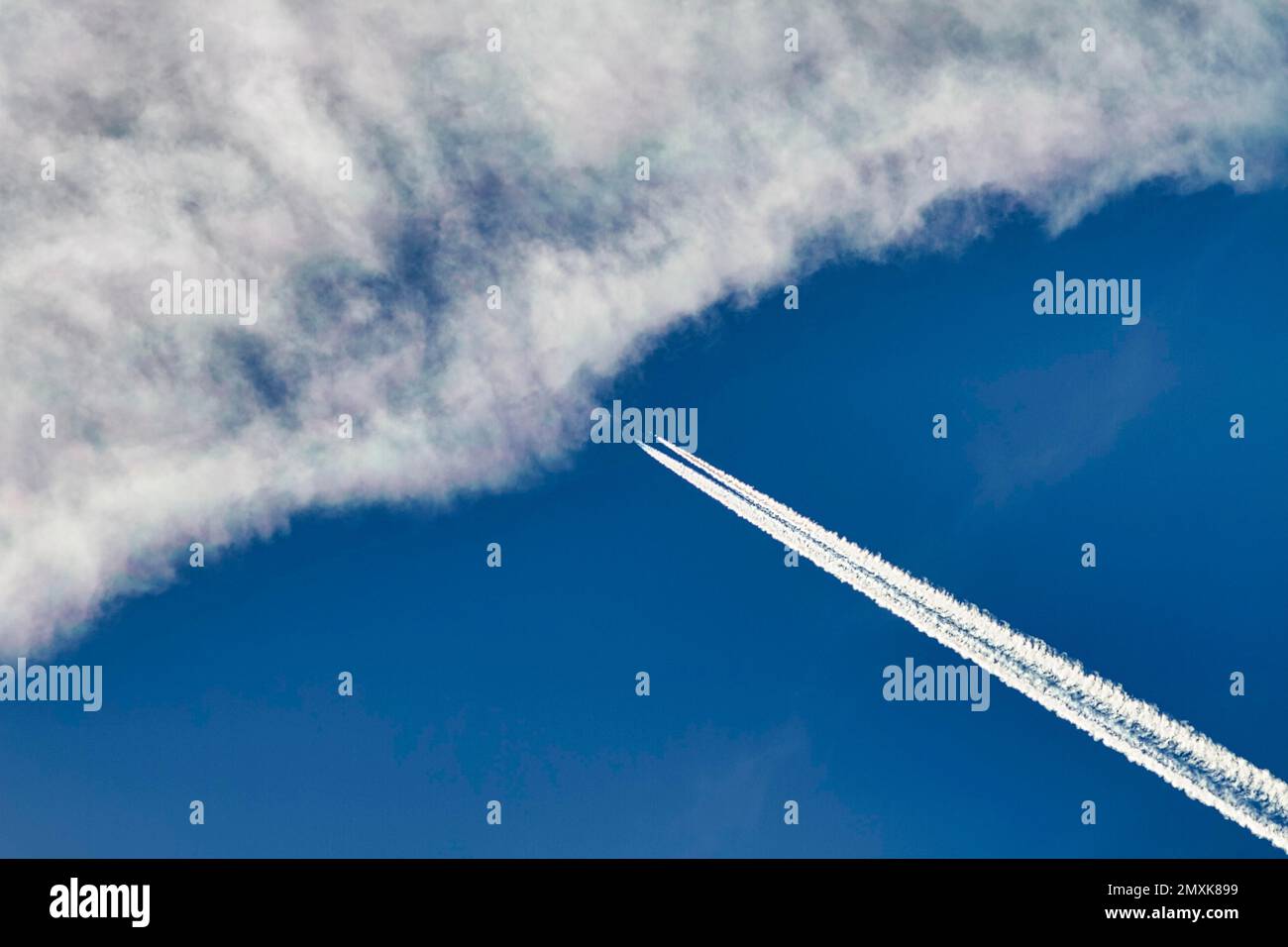 Contrails in a slightly cloudy sky, Germany, Europe Stock Photo - Alamy