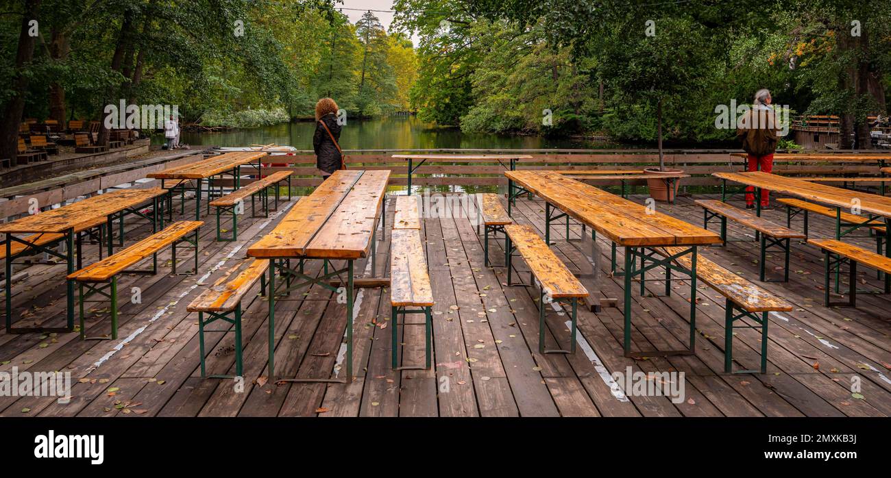Tables and benches in an empty beer garden in the park, Berlin, Germany ...